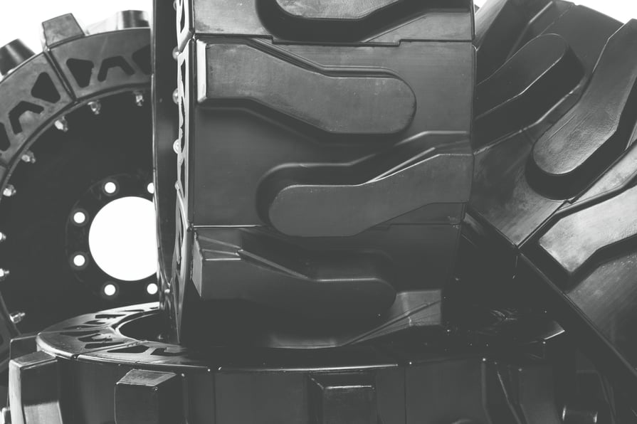 How are Solid Skid Steer Tires Secured to a Rim?